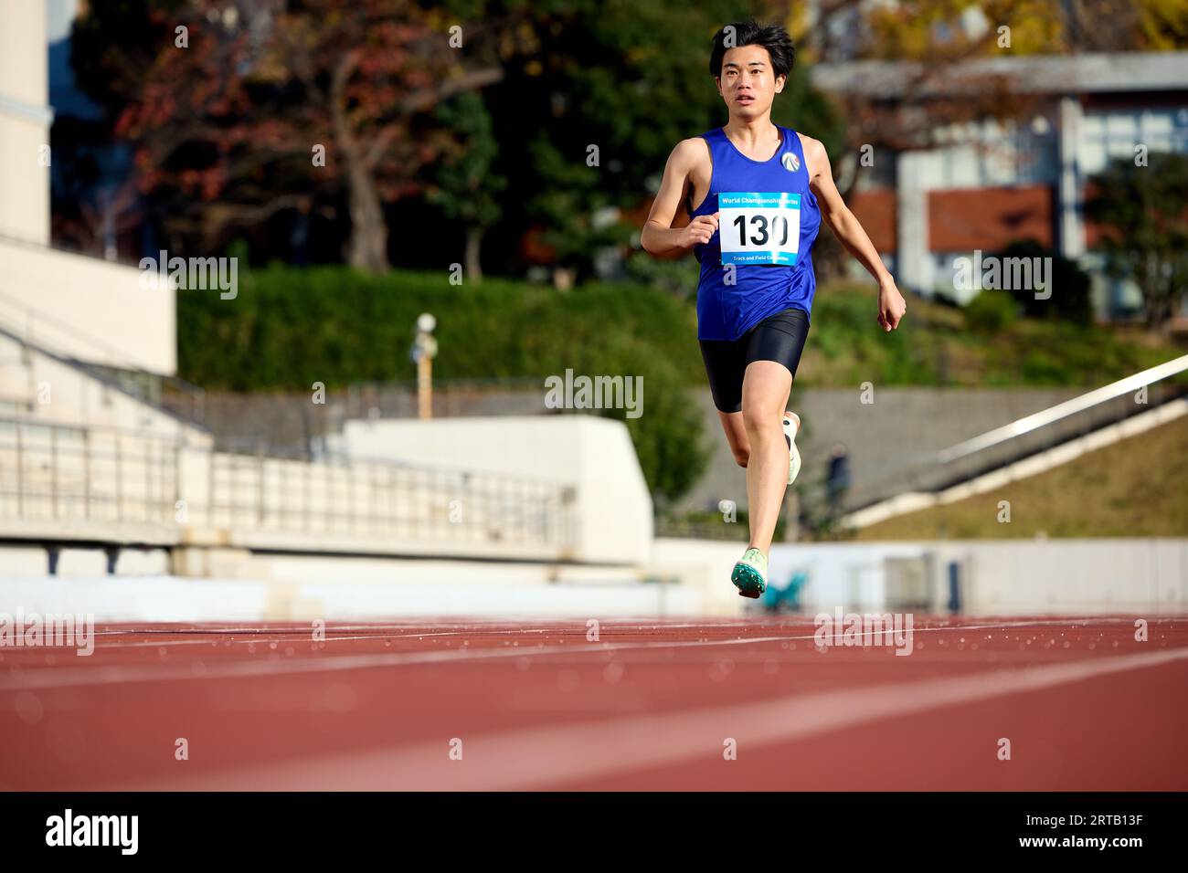 Japanese athlete running on track Stock Photo - Alamy