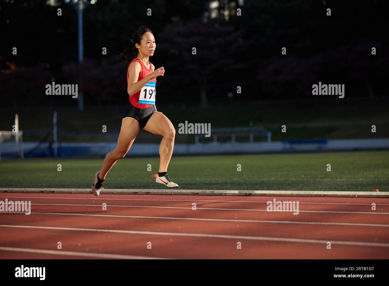 Japanese athlete running on track Stock Photo - Alamy