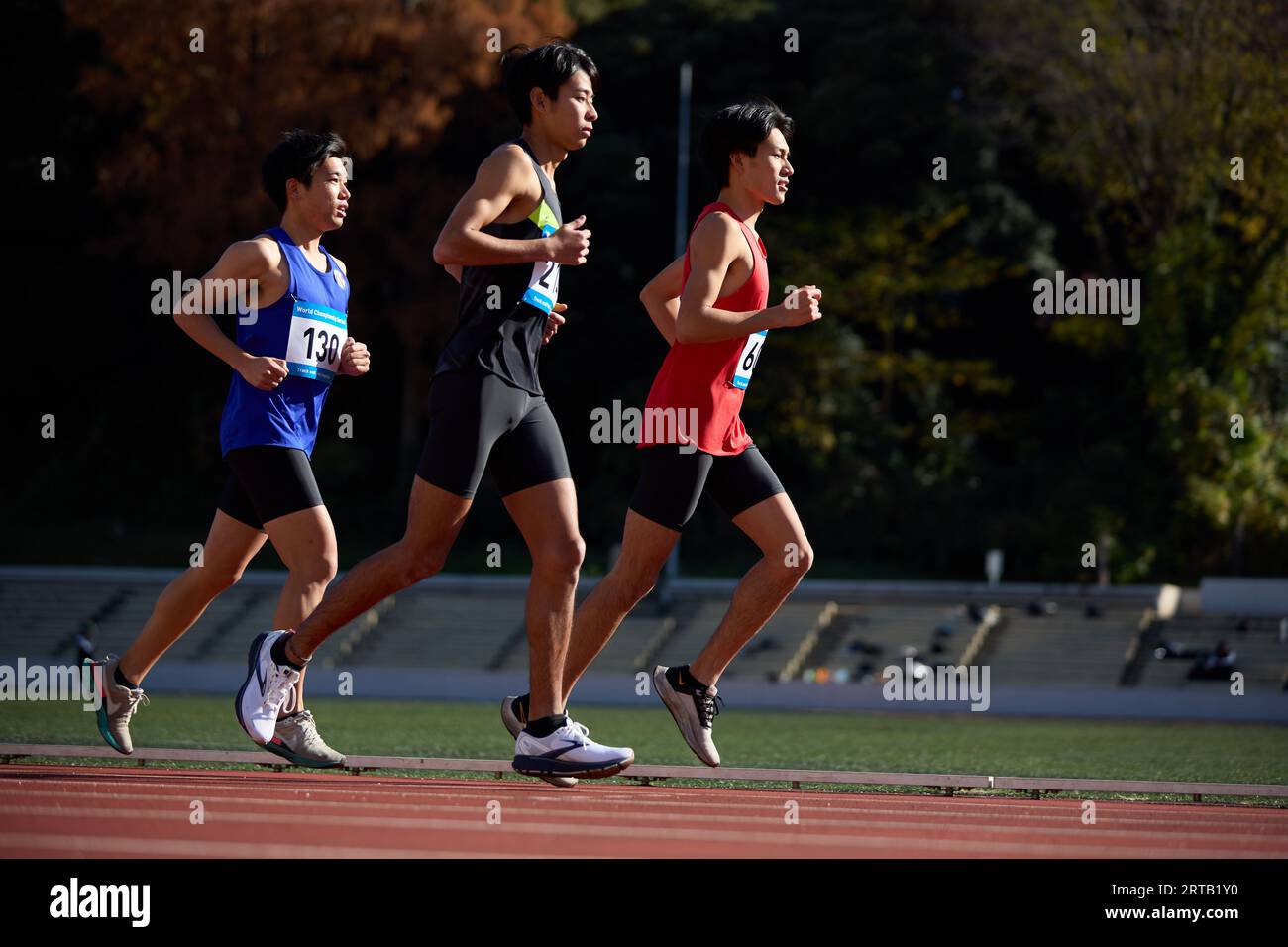Japanese athletes running on track Stock Photo - Alamy