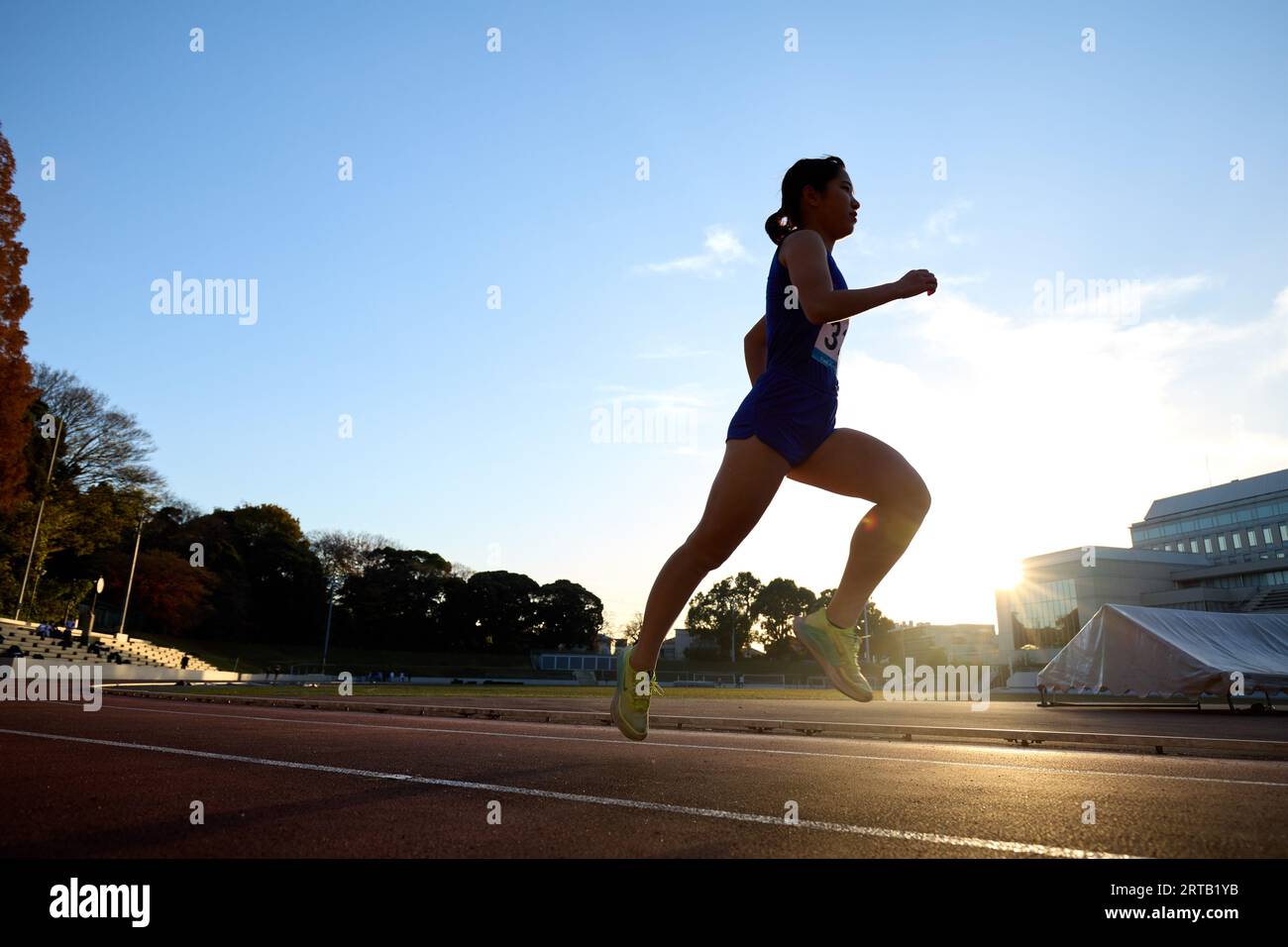 Japanese athlete running on track Stock Photo - Alamy