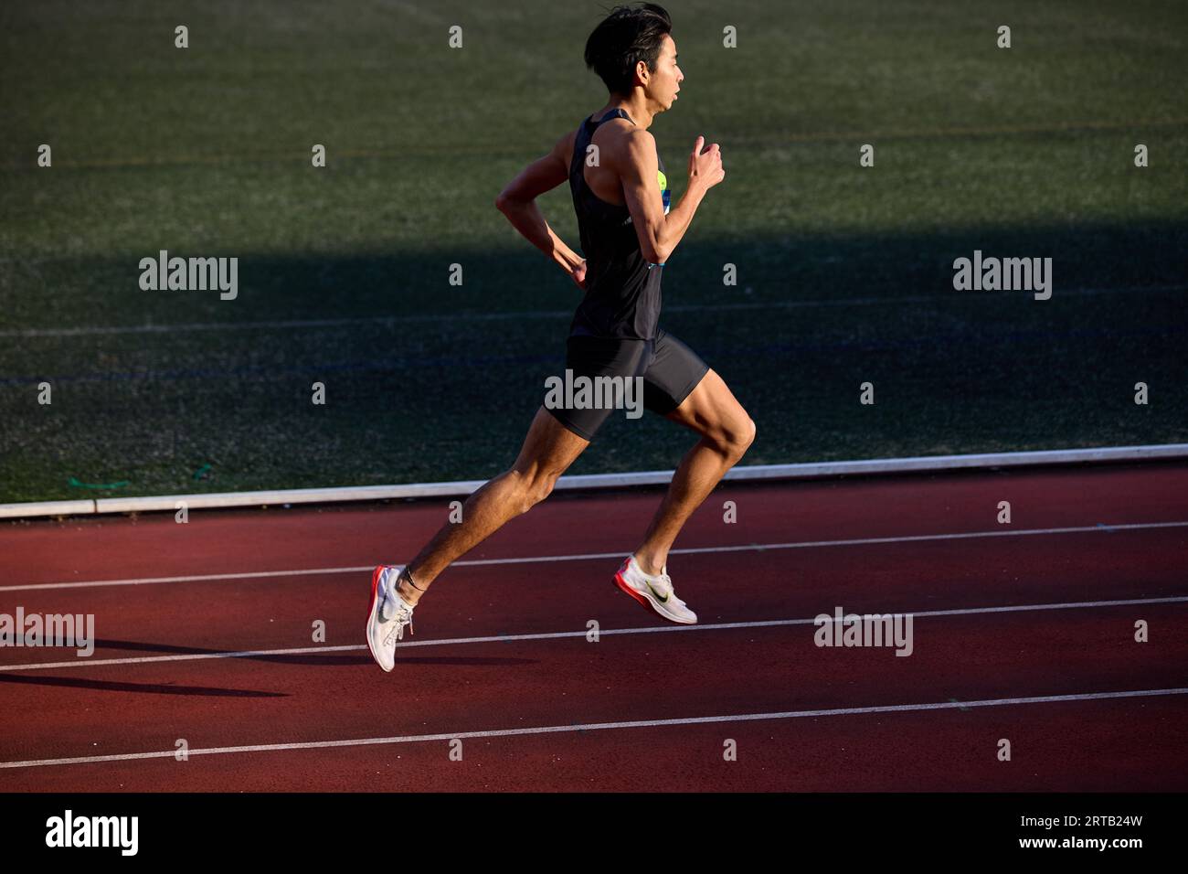 Japanese athlete running on track Stock Photo - Alamy