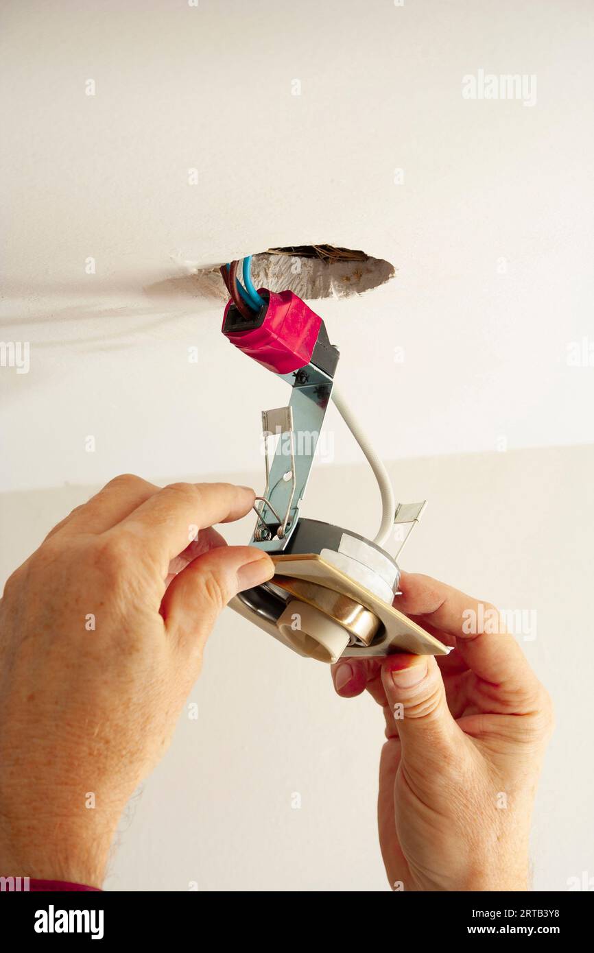 The process of hanging an LED lamp on the ceiling Stock Photo - Alamy