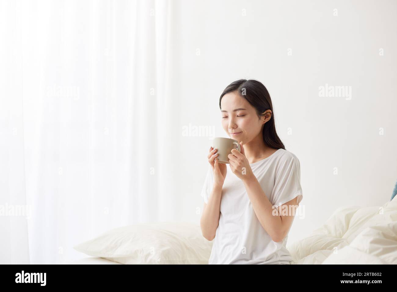 Young woman smelling cup hi-res stock photography and images - Alamy