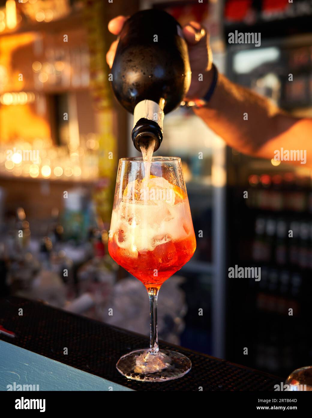 Spritz traditional cocktail with alcohol being prepared in a beach bar ...