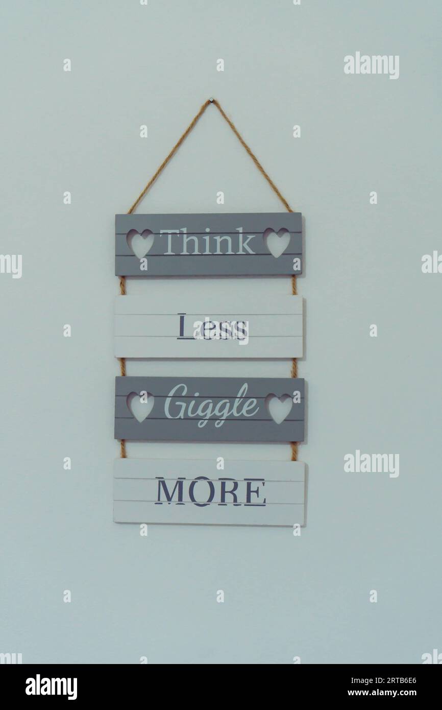 Composition of wooden plaques boards with inscription words think less ...