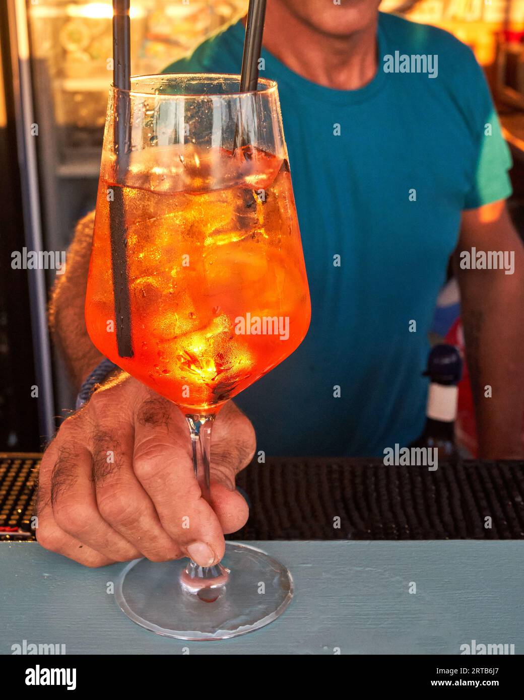 Spritz traditional cocktail with alcohol being prepared in a beach bar ...