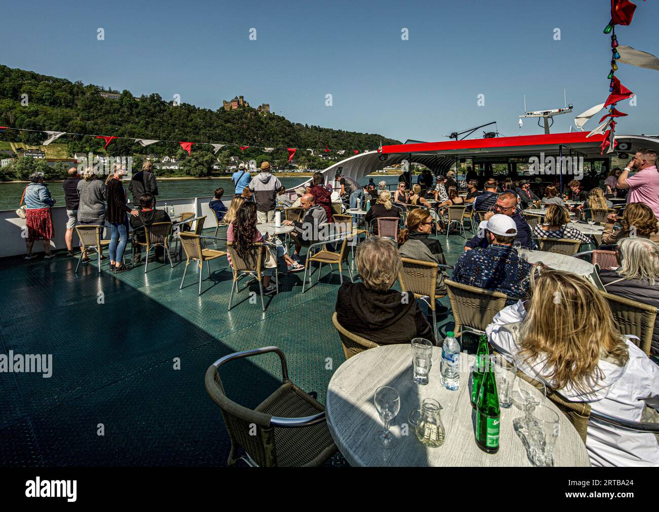 Passengers during a panoramic trip on the Rhine with a view of the ...