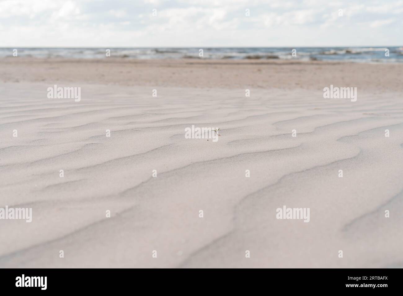 Close-up of fantastic sandy dunes ridges ripples beach near water sea ...