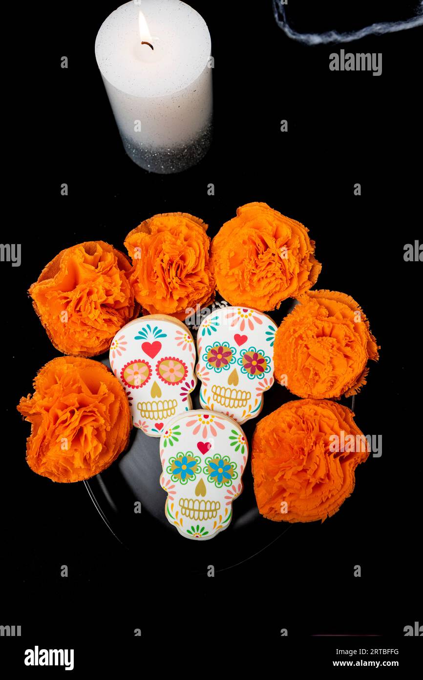 Cookies with shapes of Mexican catrinas and orange marigold flowers to ...