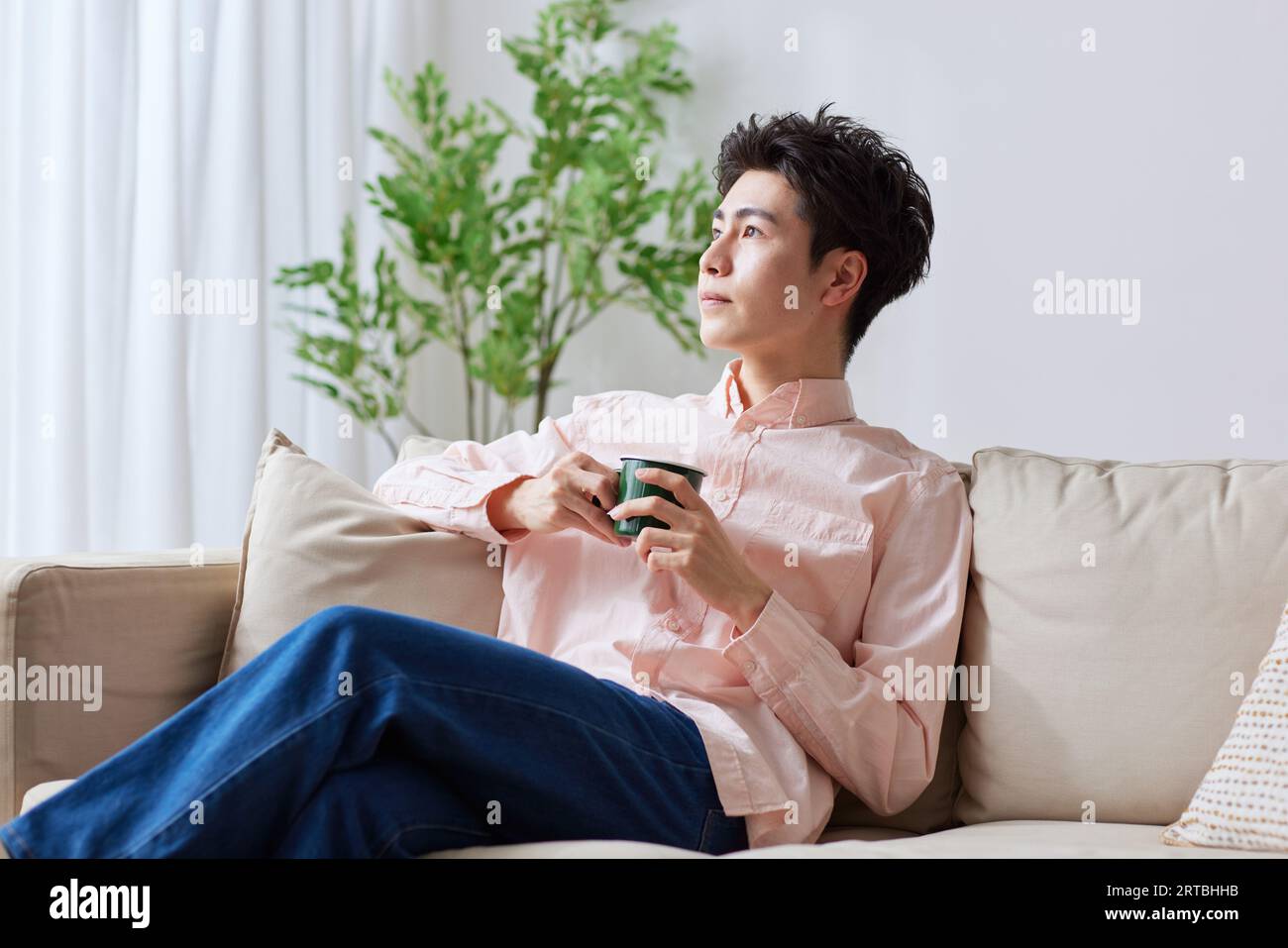 Japanese man relaxing at home Stock Photo - Alamy