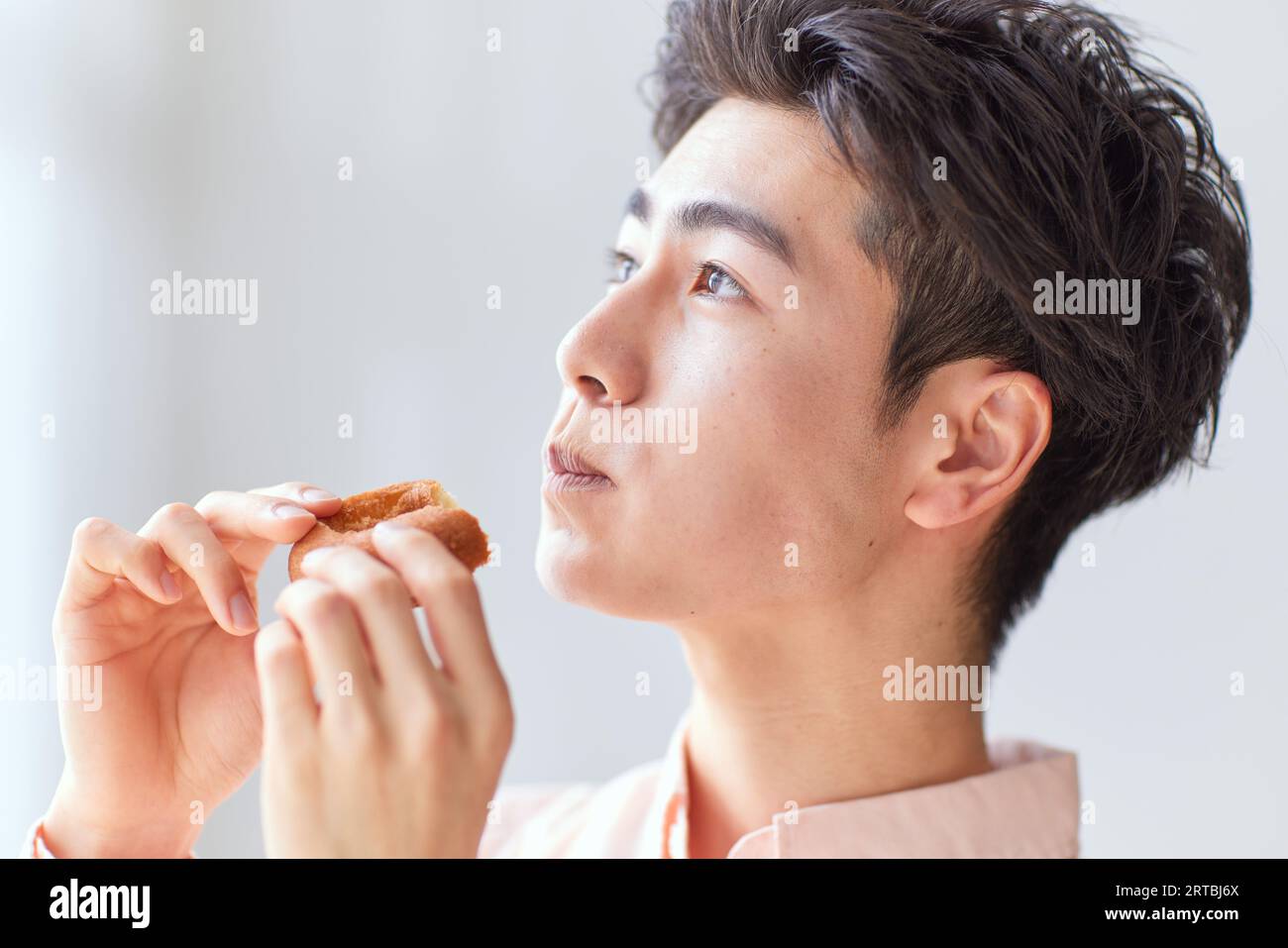 Adult man eating sweet donut hi-res stock photography and images - Alamy