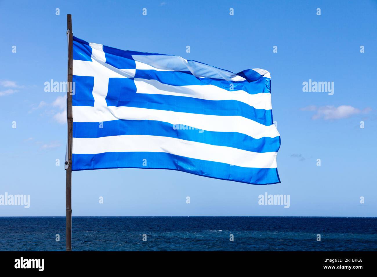 Greek flag waving atop of its pole Stock Photo - Alamy