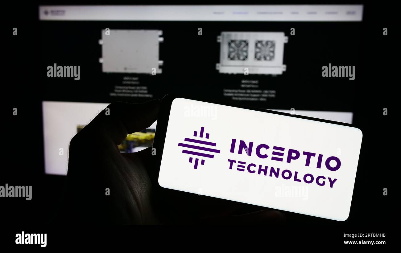 Person holding mobile phone with logo of autonomous vehicle company ...