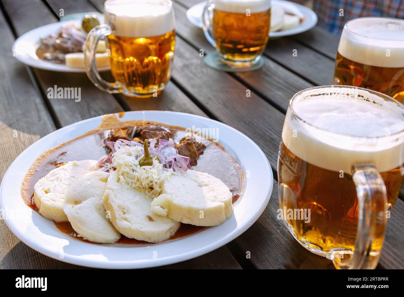 Beef goulash with Bohemian dumplings and draft beer served in in Český ...