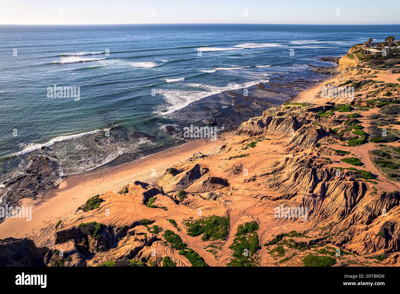 View of rocky sunny cliffs, waves and blue horizon at Sunset Cliffs, in ...