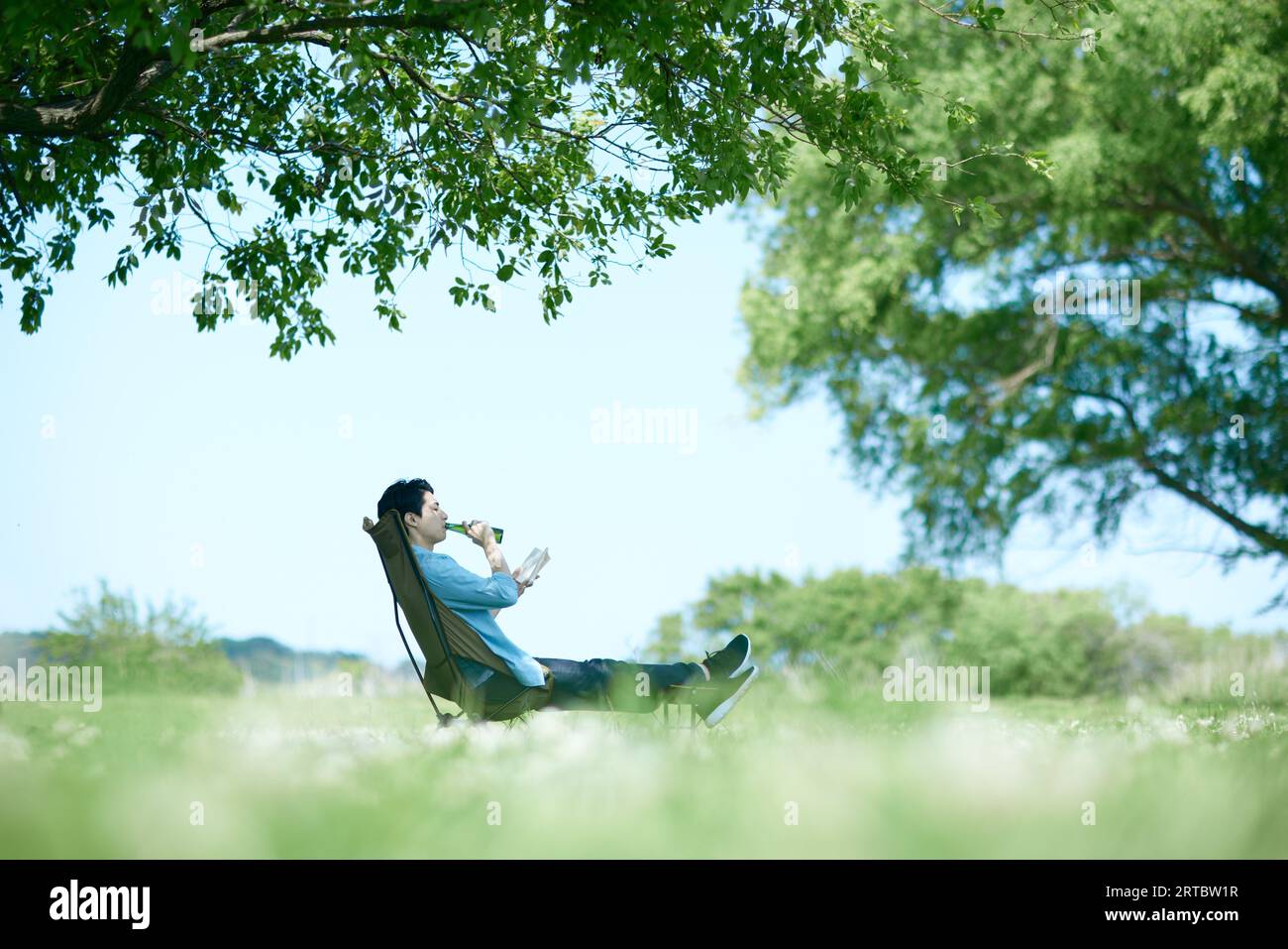 Japanese man relaxing at city park Stock Photo - Alamy