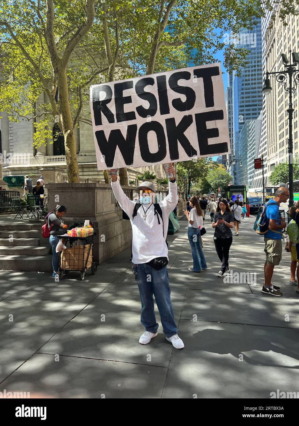 Man with a large sign at the corner of 5th Avenue and 42nd Street ...