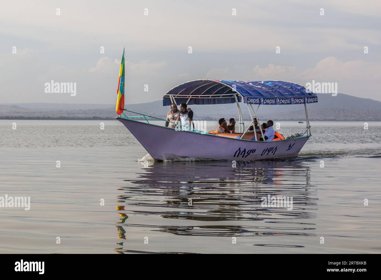 HAWASSA, ETHIOPIA - JANUARY 26, 2020: Tourists at a small boat on ...