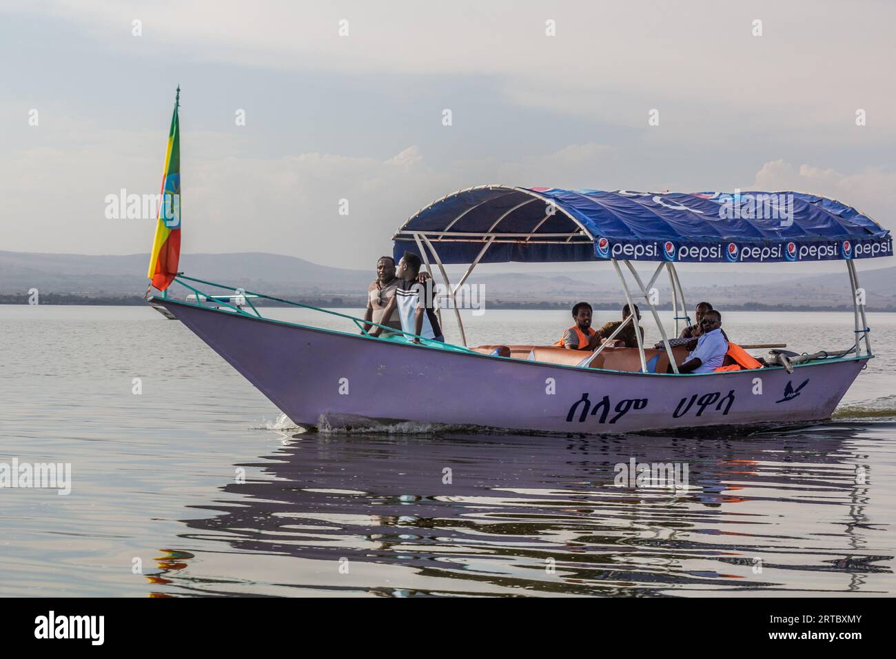 HAWASSA, ETHIOPIA - JANUARY 26, 2020: Tourists at a small boat on ...