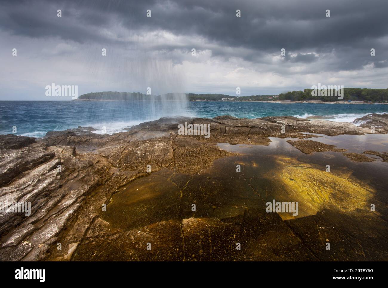 Landscape of sea water splashing at rocks at coast Stock Photo - Alamy