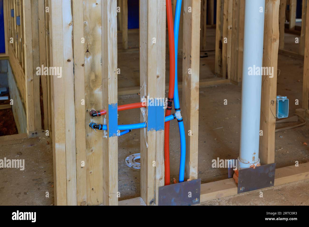 Water system integration in a new home construction with red and blue ...