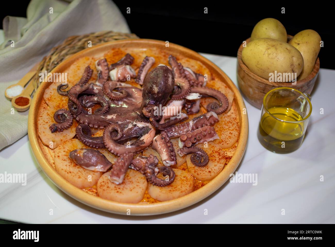 Octopus Typical Spanish dish served with paprika, salt, potatoes and ...