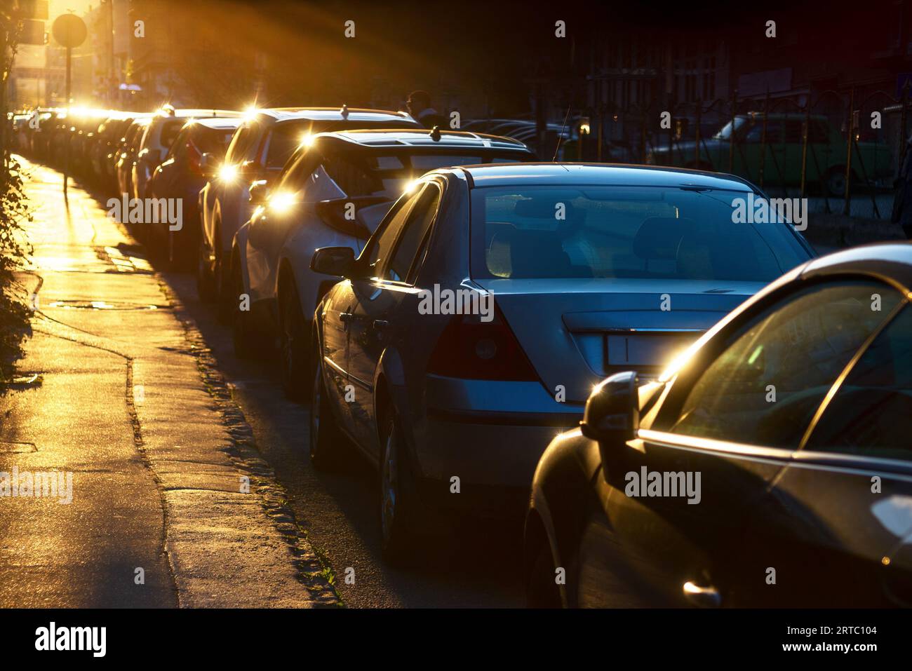 Cars parked in line on a roadside Stock Photo - Alamy