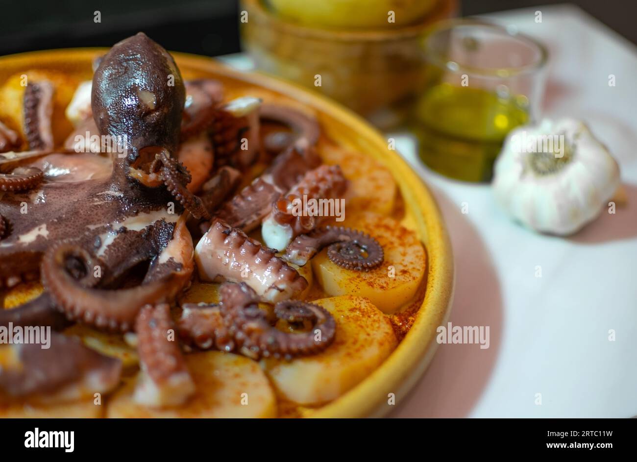 Octopus Typical Spanish dish served with paprika, salt, potatoes and ...