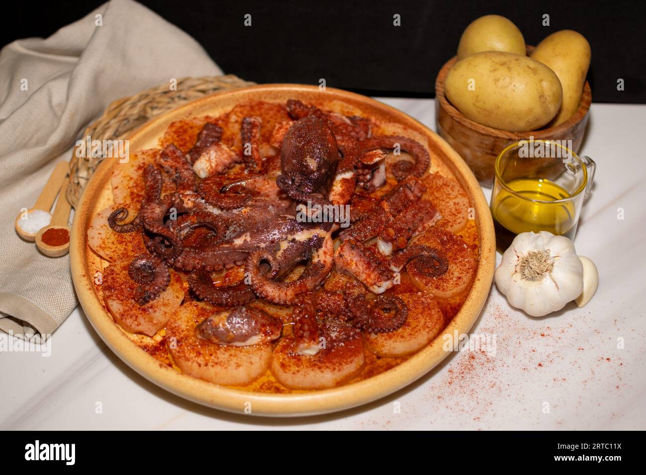 Octopus Typical Spanish dish served with paprika, salt, potatoes and ...