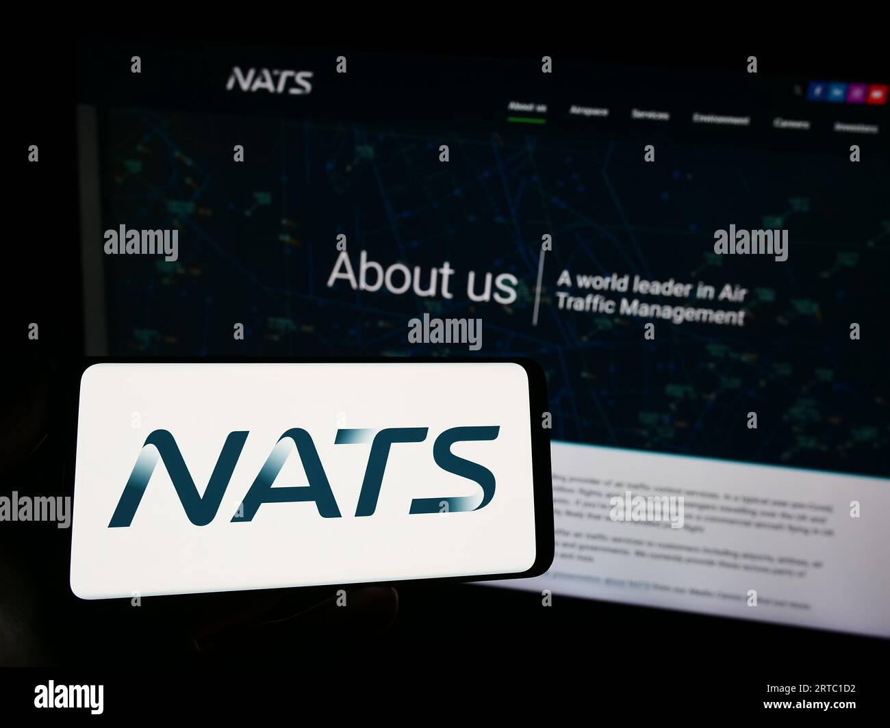 Person holding smartphone with logo of British air traffic control ...