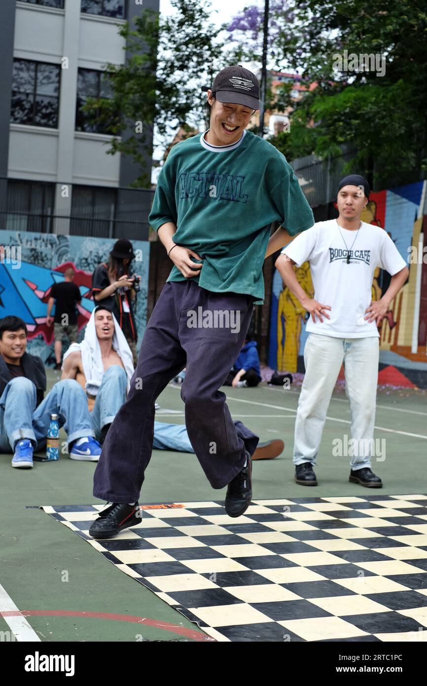 A tall male dancer in baggy Hip Hop gear dancing at a Breakdancing and ...