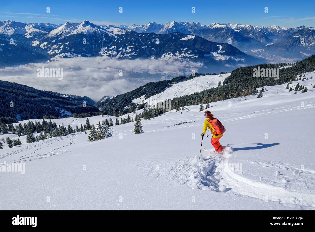 Woman on ski tour descending from Wiedersberger Horn, Tux Alps and ...