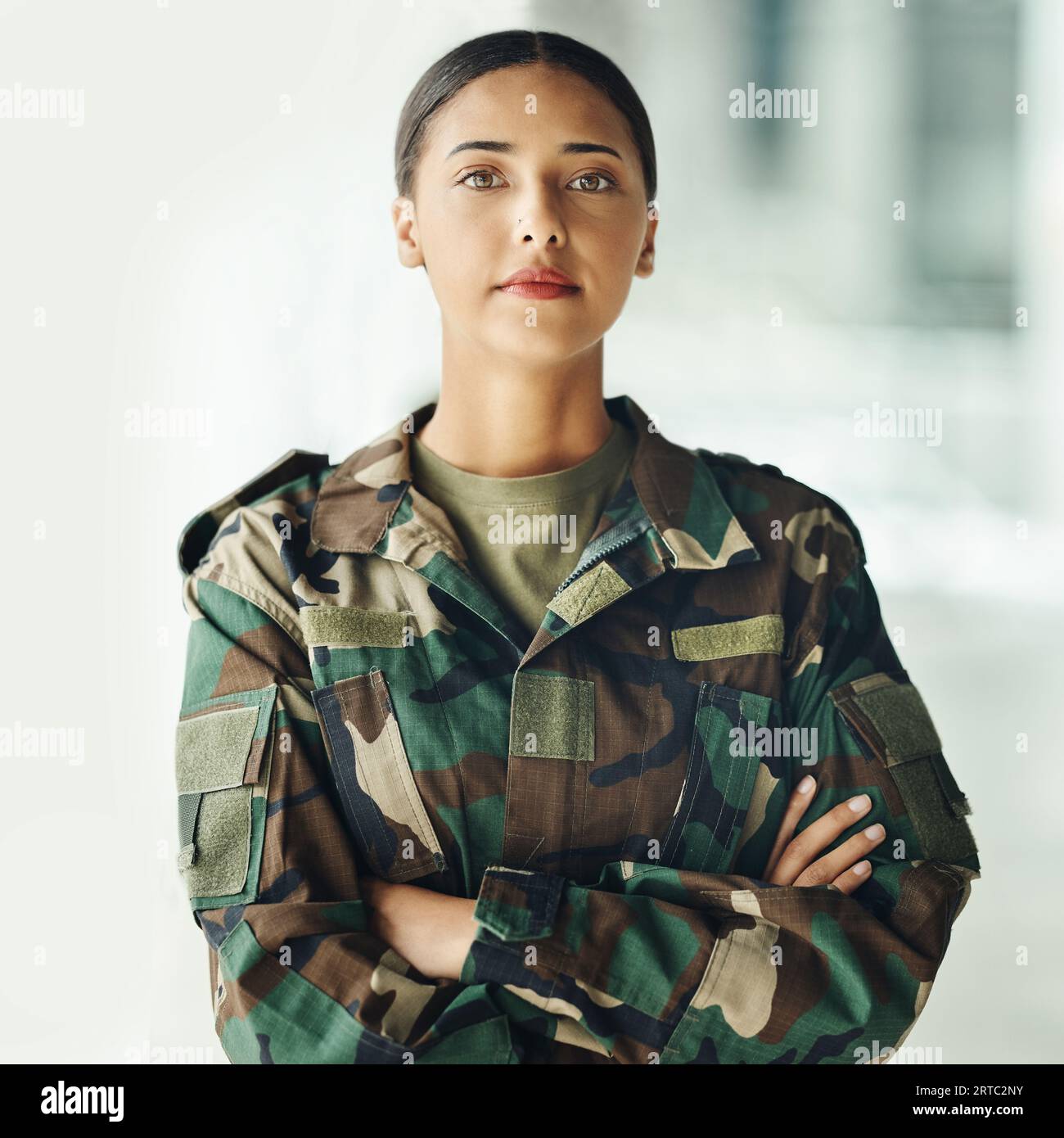 Confident soldier portrait, woman and arms crossed in army building, pride and professional hero ...