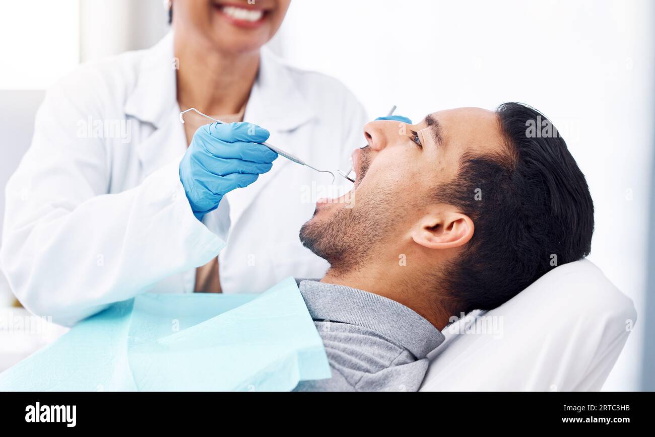 Man, dentist and check teeth with tools for dental cosmetics ...