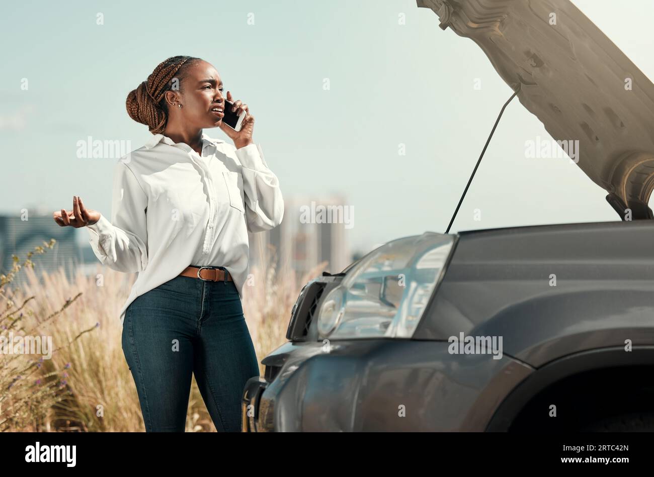 Stress, broken car and black woman on a phone call in the road with ...