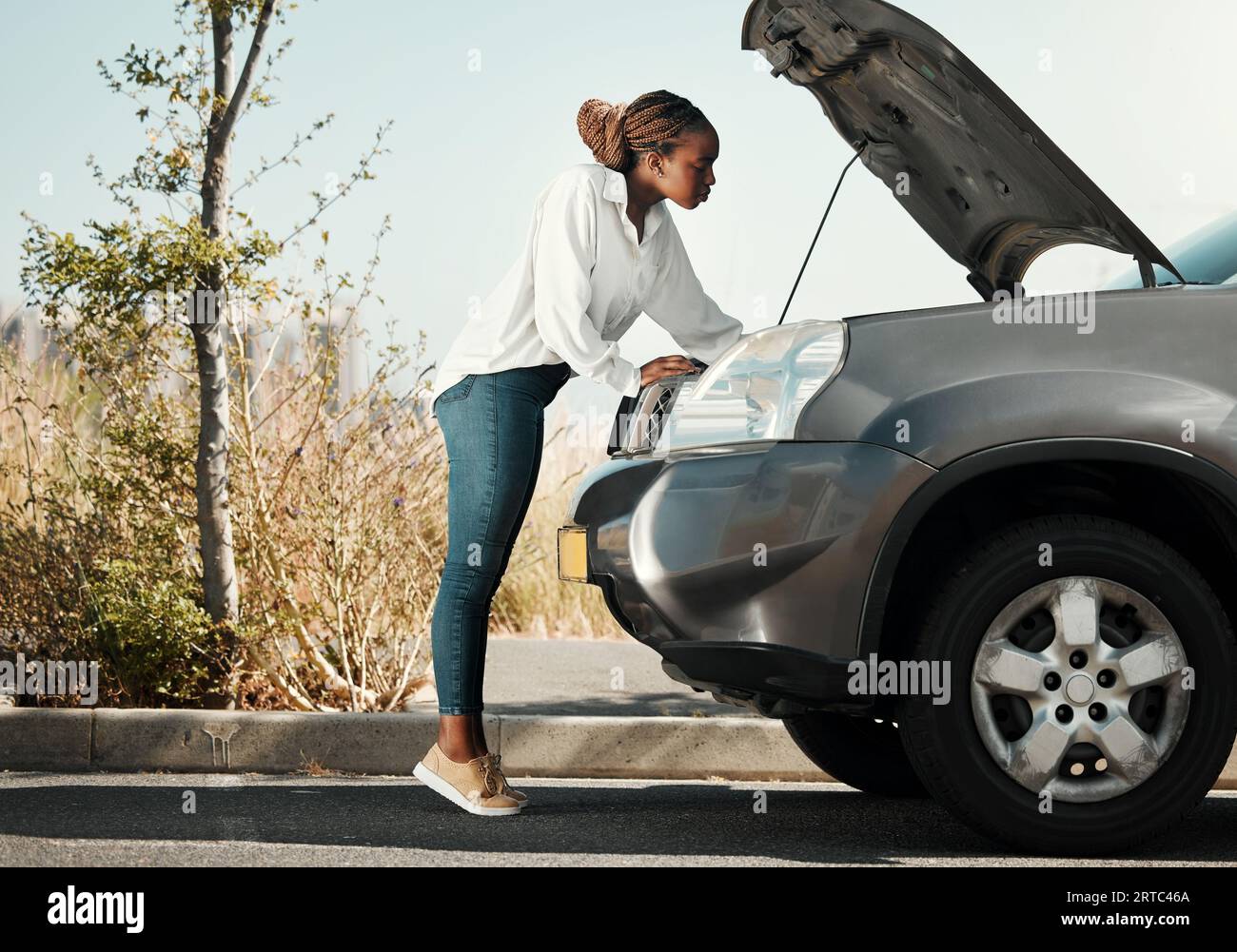 Mechanic, broken car and black woman in the road fixing her engine ...