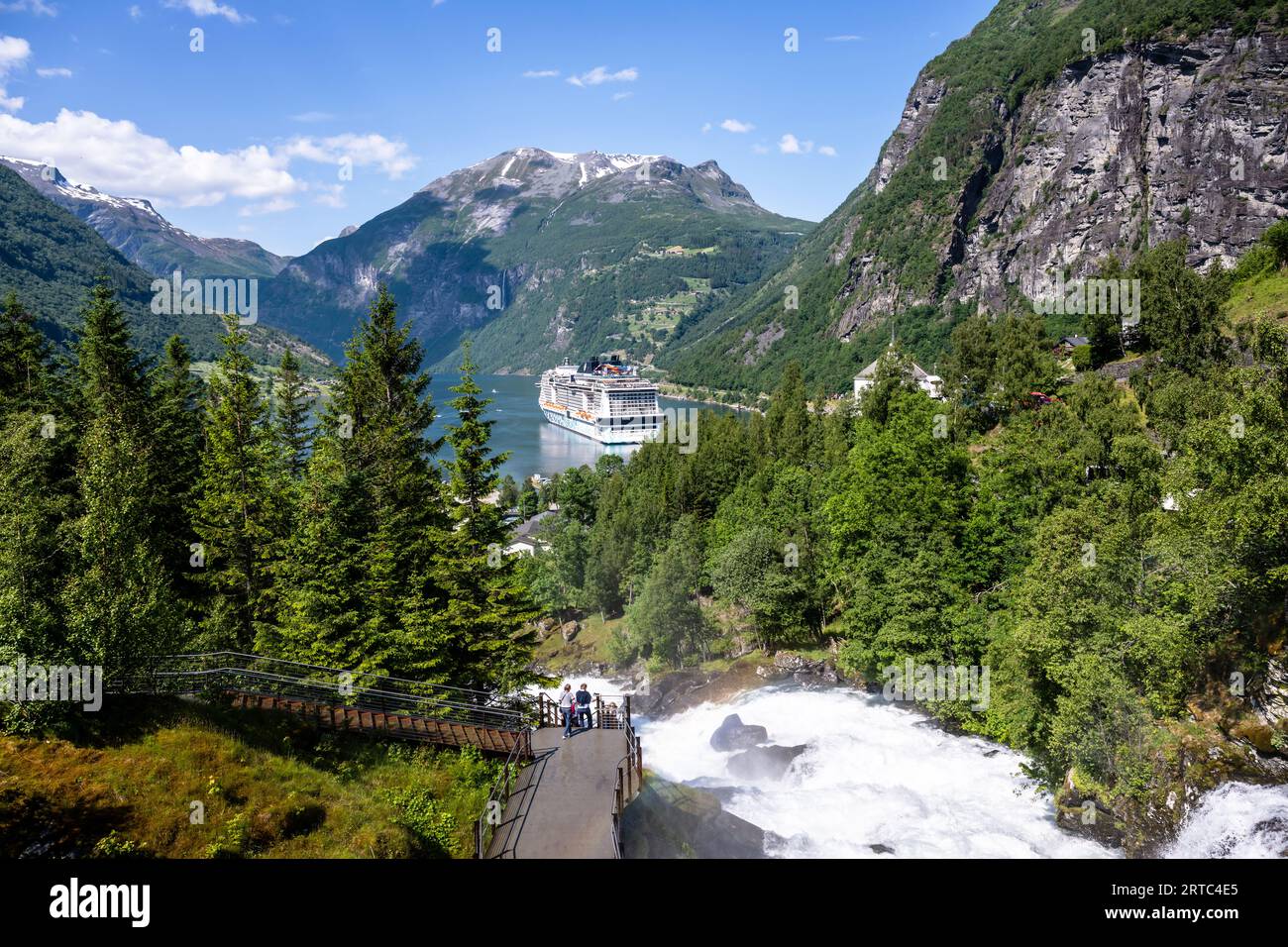 View of waterfall hiking trail and fjord with cruise ship in Geiranger ...
