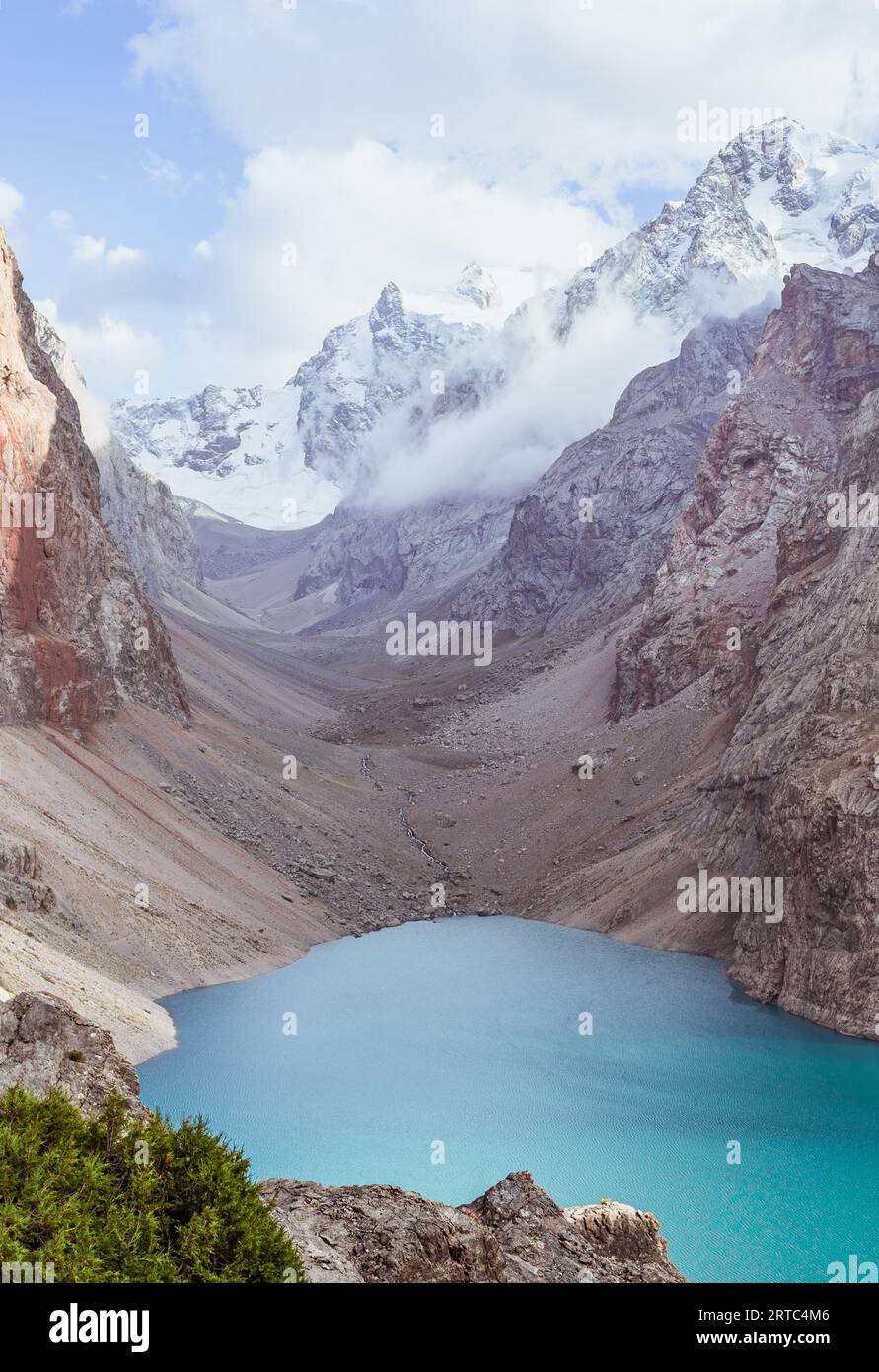 Mountain lake with azure water and snowy peaks in the heart of ...