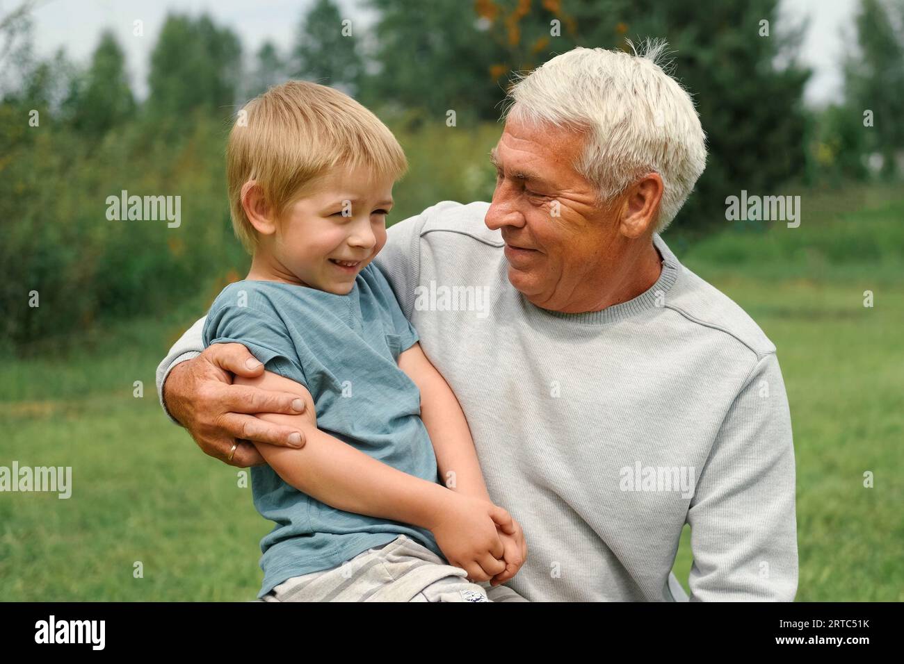 Grandfather and grandchild baby have fun during walk In Park. Happy ...