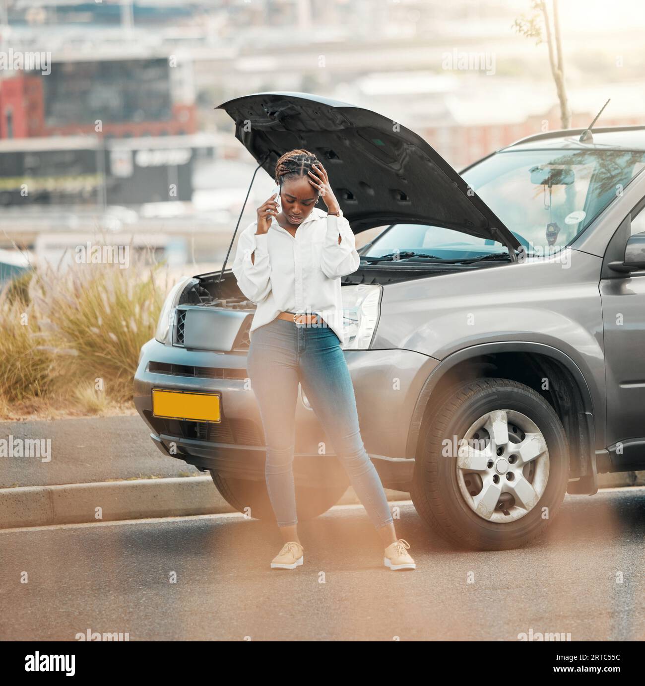 Frustration, phone call and black woman with stuck car in the road with ...