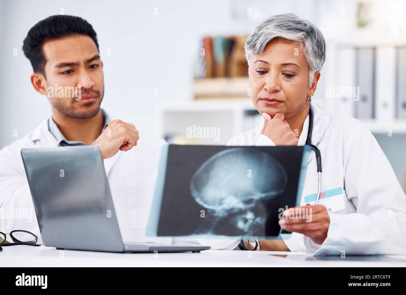 Doctor, healthcare and skull xray analysis, collaboration and laptop ...