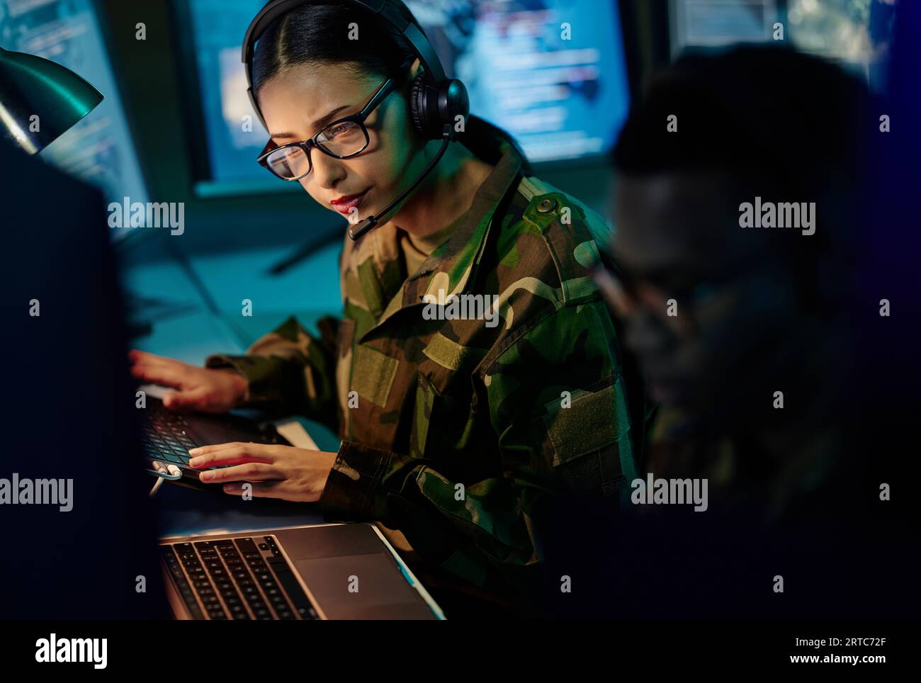 Military control room team, headset and woman with computer and tech for communication. Security ...