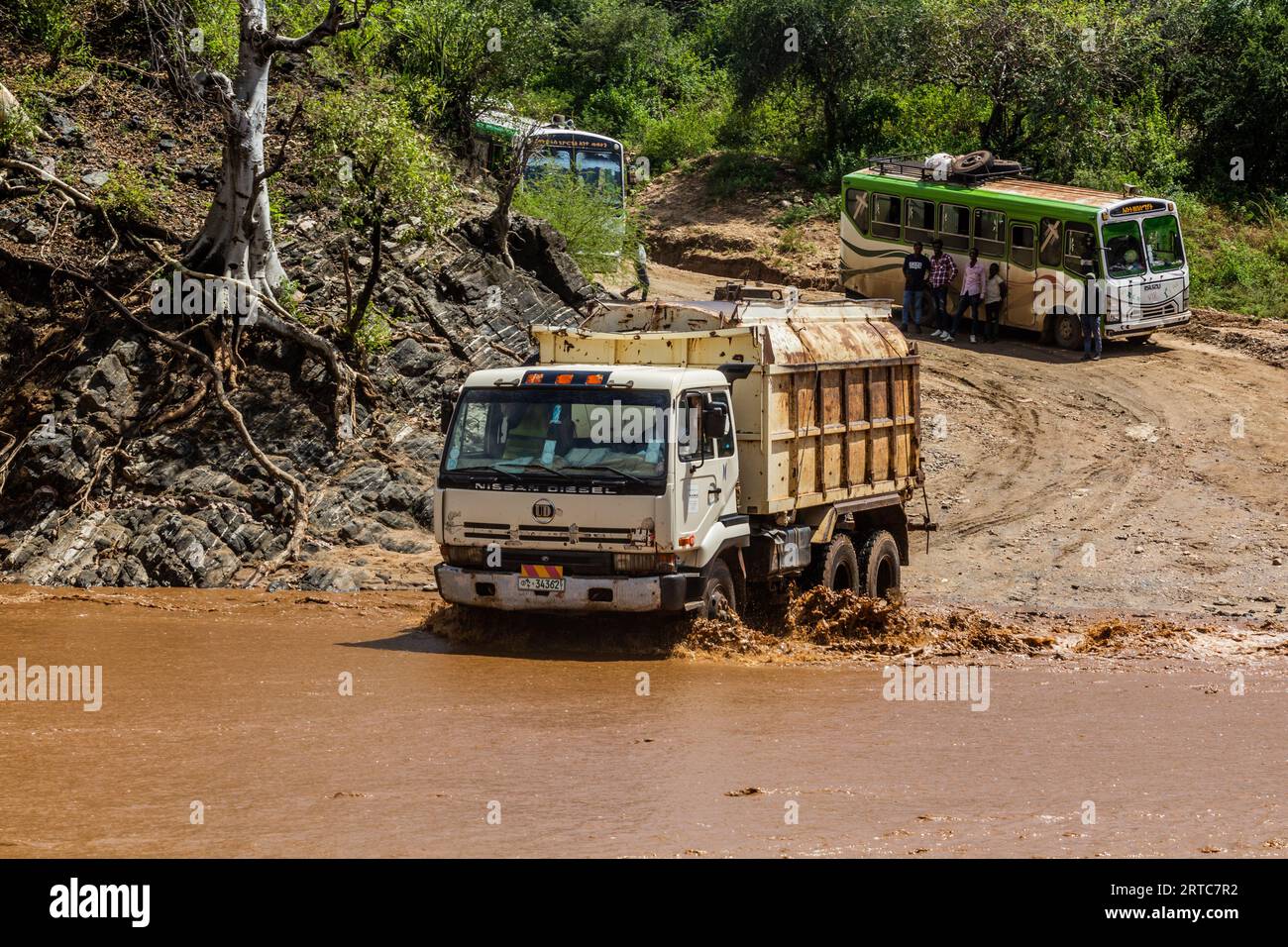 OMO VALLEY, ETHIOPIA - FEBRUARY 4, 2020: Truck crossing Kizo river ...