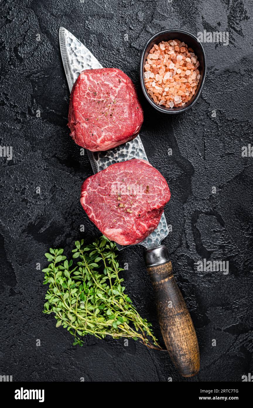 Fillet Mignon Beef steak, raw dry aged marble meat. Black background ...