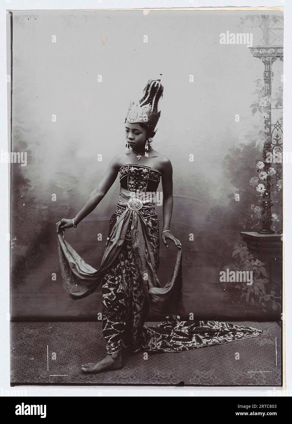 Studio portrait of a young Indonesian woman in batik sarong and ...