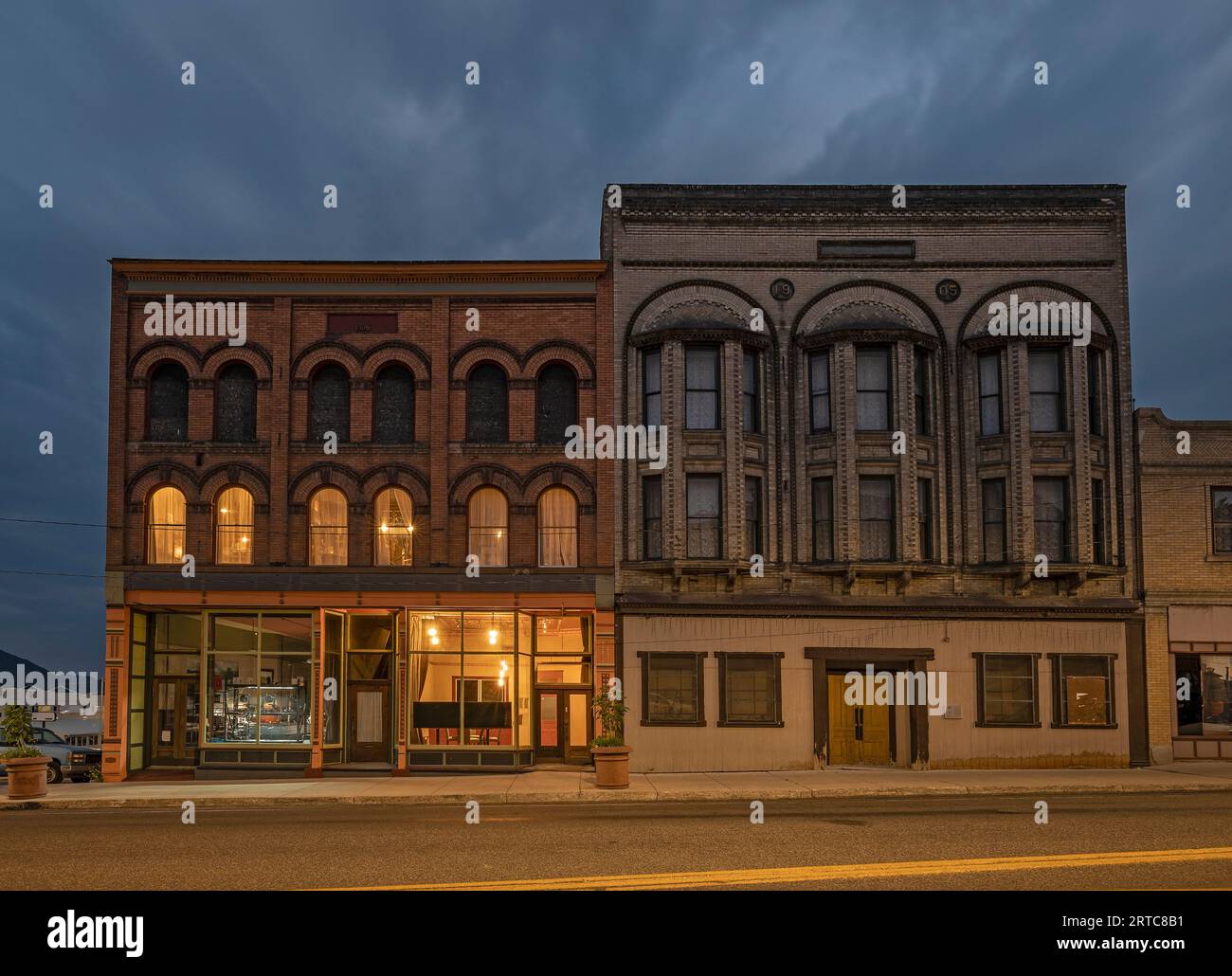 Illuminated historic brick buildings at night in downtown Butte ...