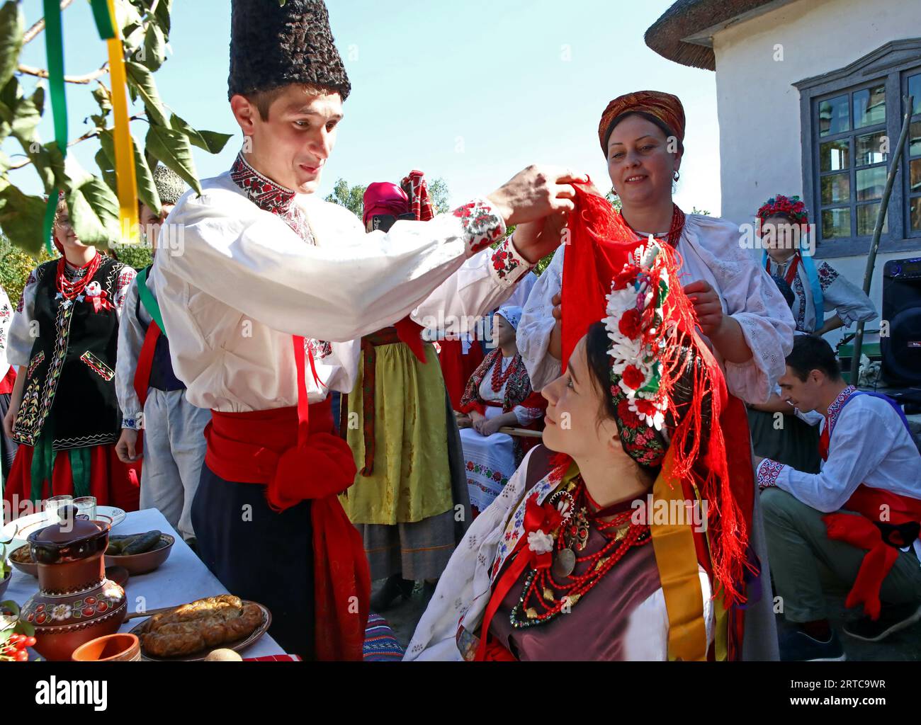 KYIV, UKRAINE - SEPTEMBER 10, 2023 - The groom lifts a headscarf ...