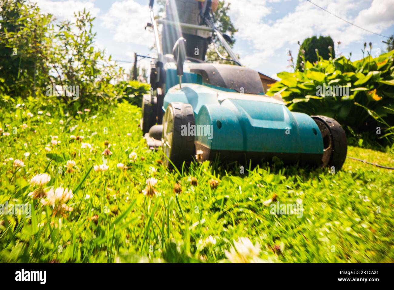 Lawn mover on green grass in modern garden or backyard. Machine for ...