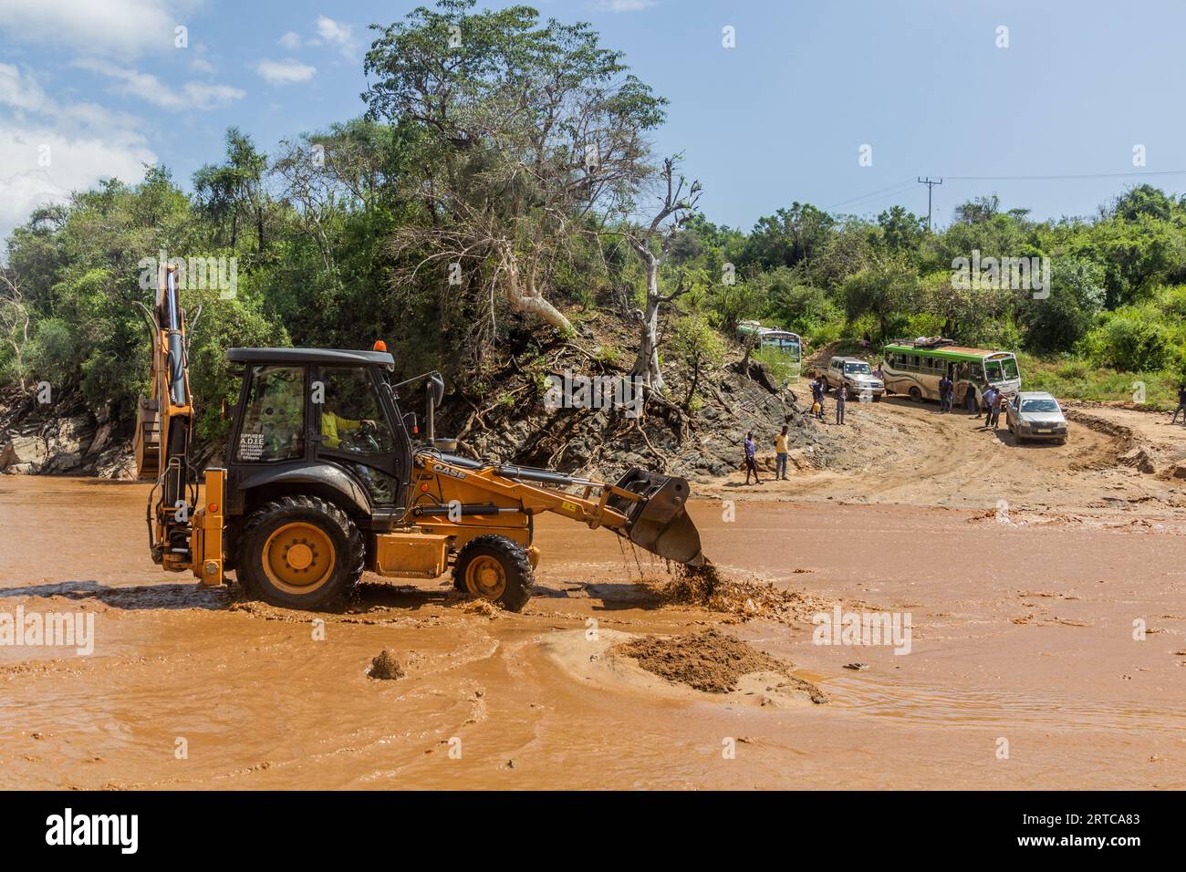 OMO VALLEY, ETHIOPIA - FEBRUARY 4, 2020: Bulldozer leveling a ford ...