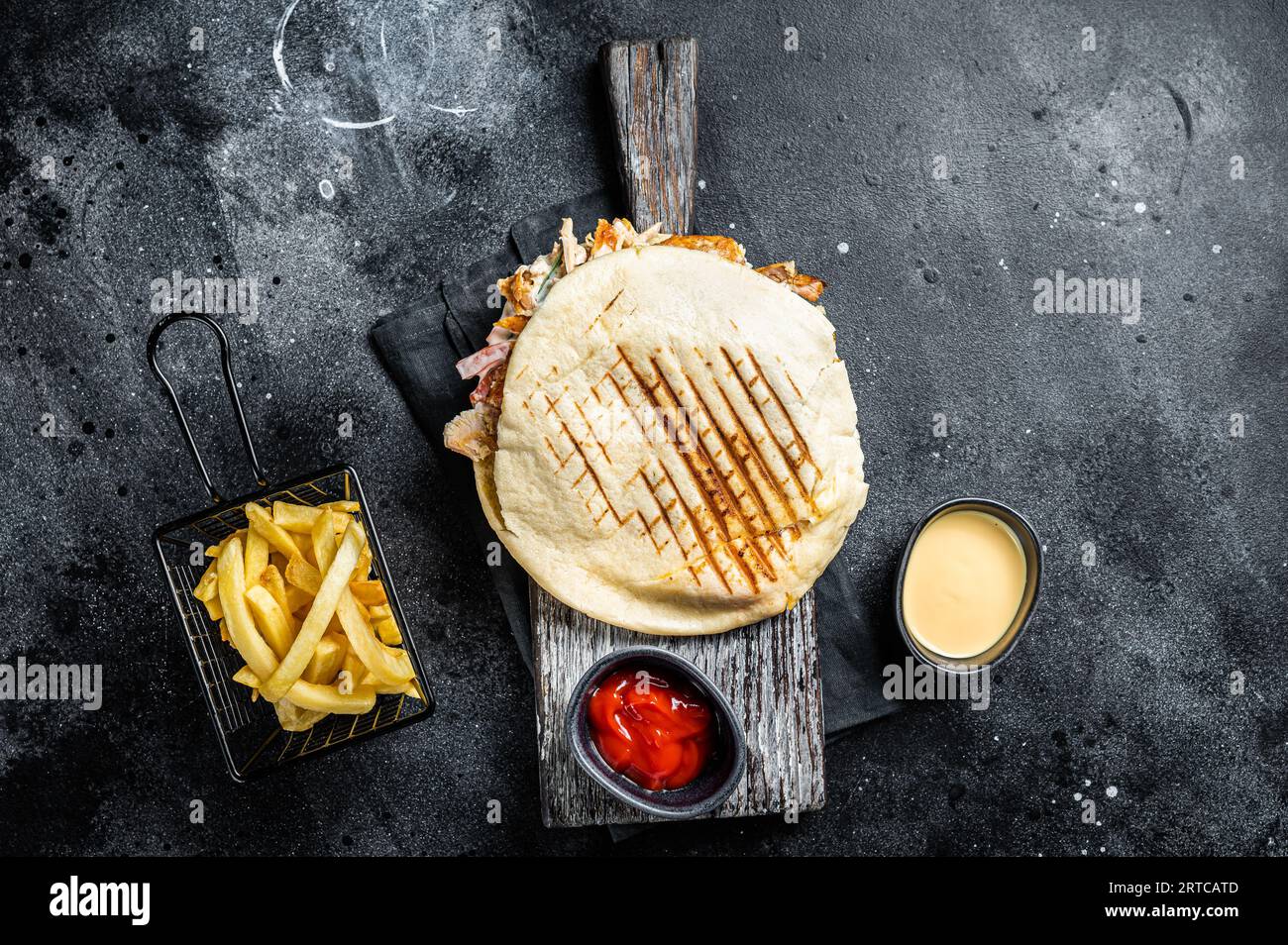 Turkish doner kebab in grilled pita bread with chicken meat. Black ...